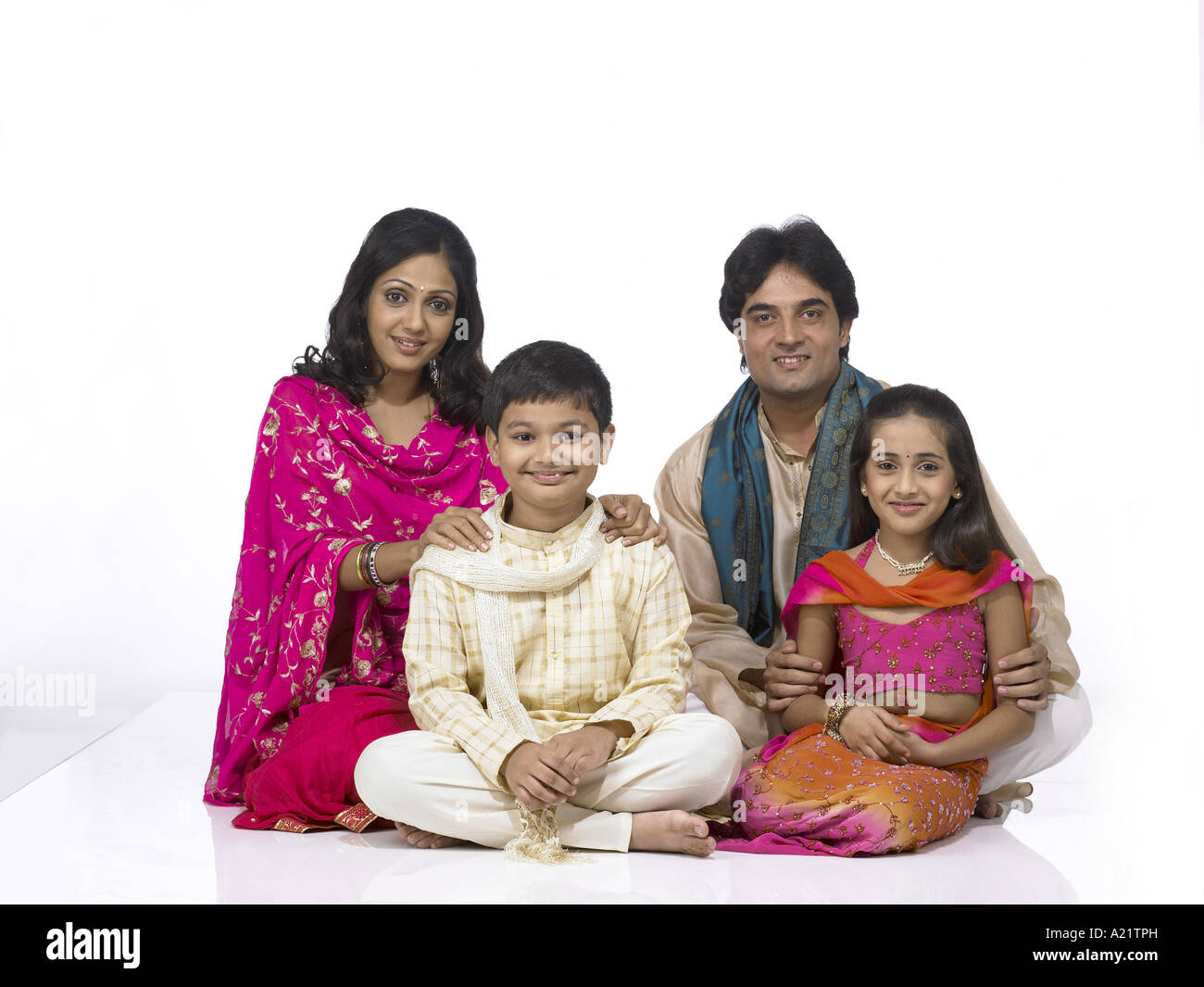 South Asian Indian family with father mother son and daughter sitting ...