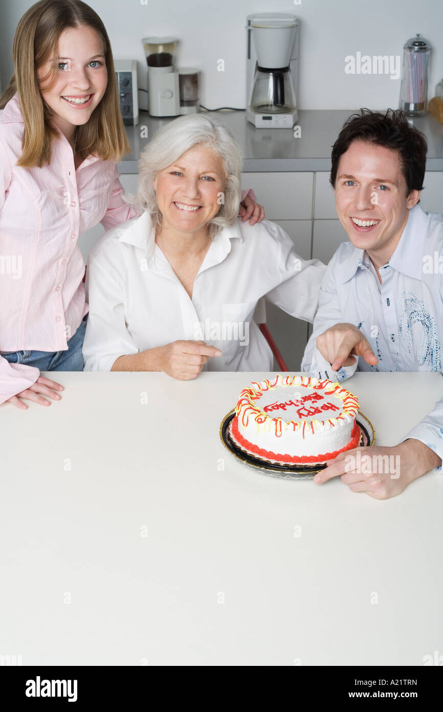 People sitting around birthday cake hi-res stock photography and images ...