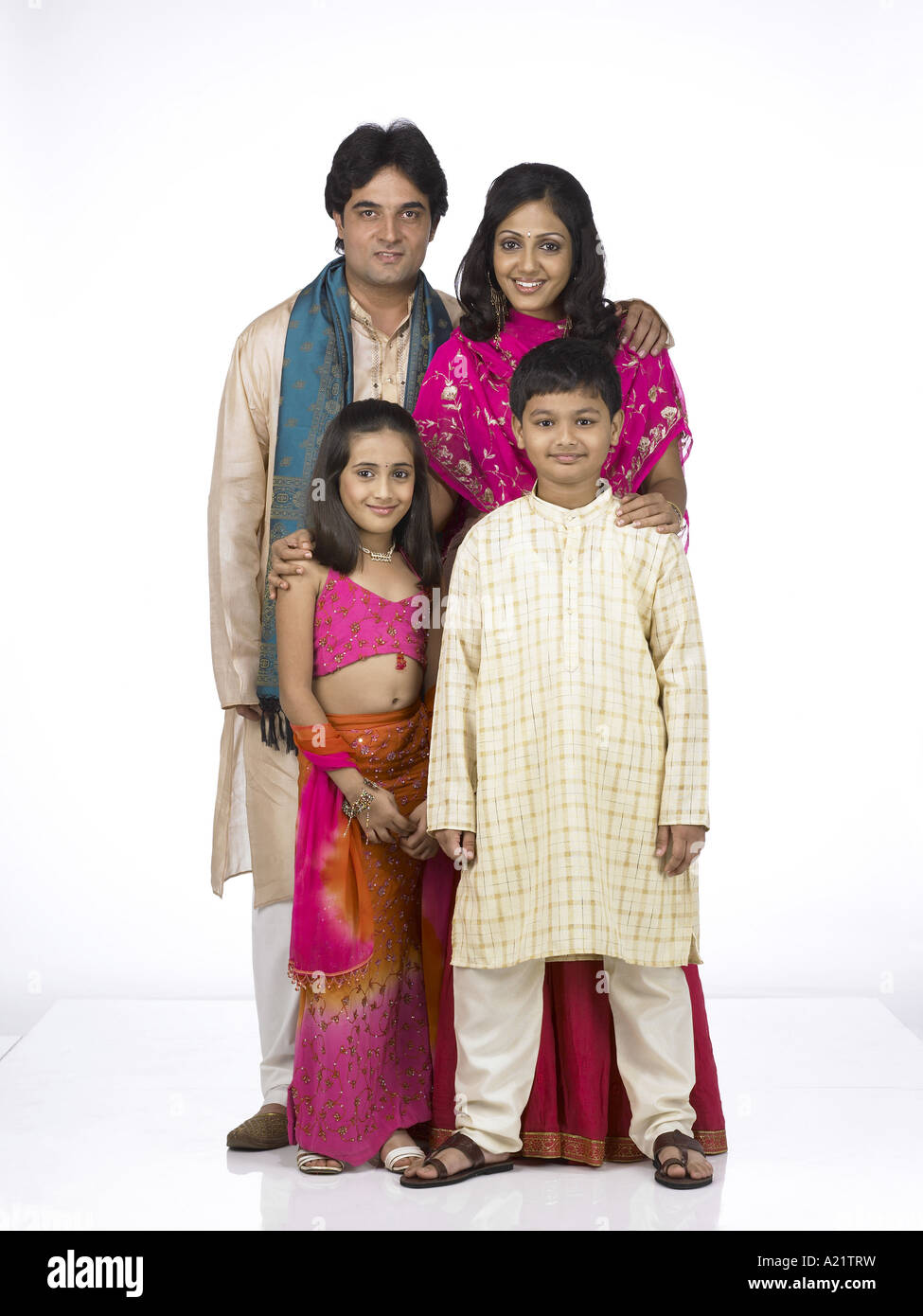 South Asian Indian family with father mother son and daughter standing ...