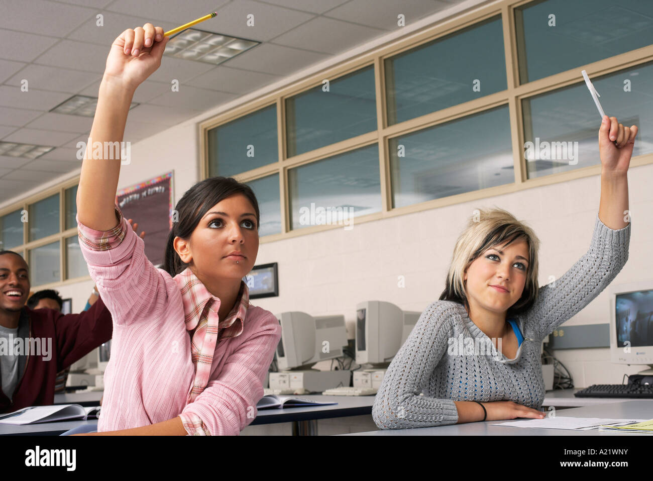 Smiling teenage boy raising hand class hi-res stock photography and ...