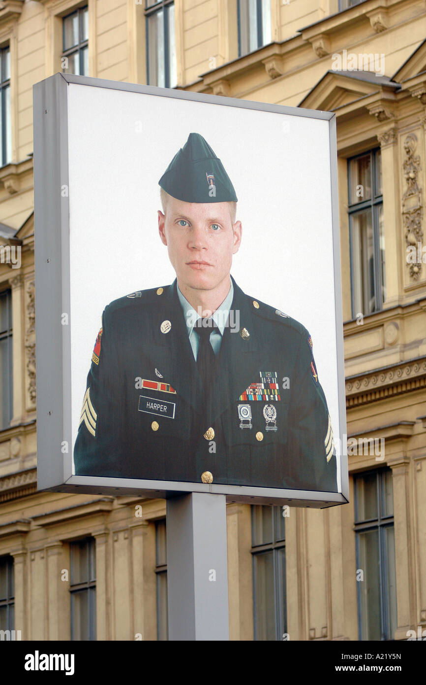 Commemorative poster of US soldier at Checkpoint Charlie in Berlin ...