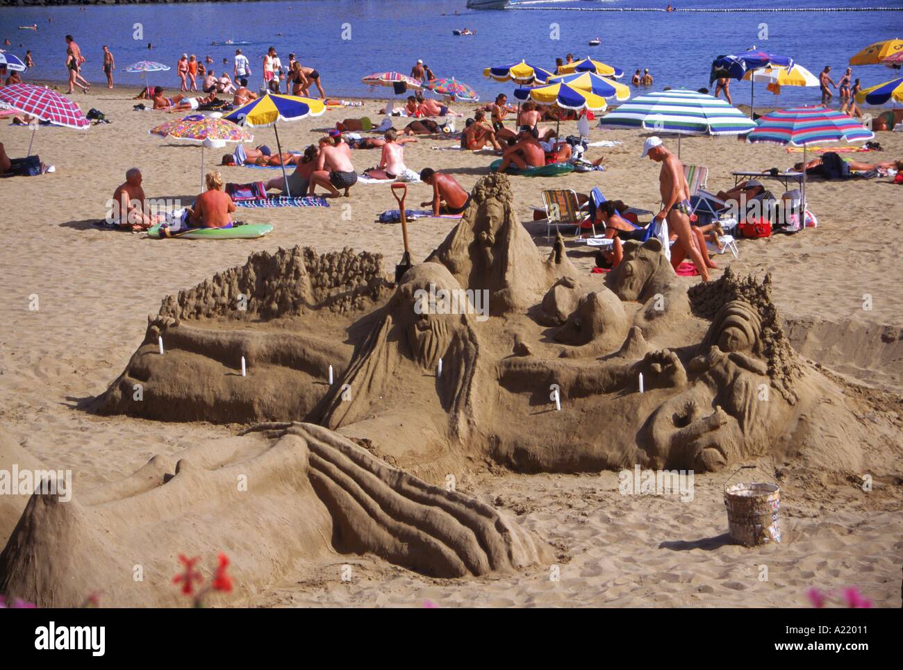Sand castles and tourists on a beach K Hudson Stock Photo - Alamy