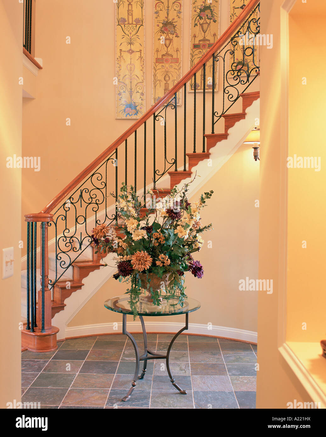 Front foyer with flowers and spiral staircase Stock Photo - Alamy