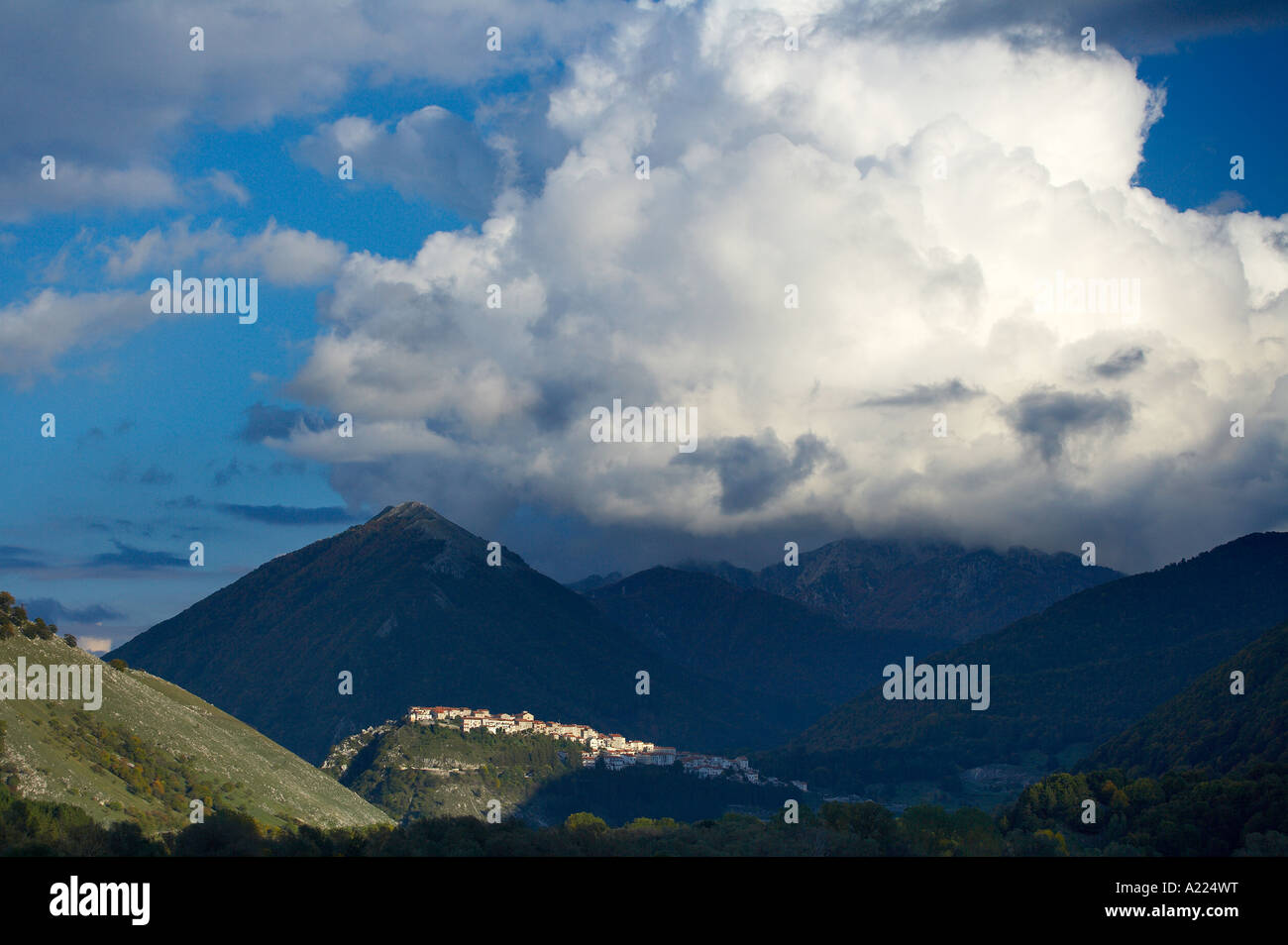 the village of Opi picked out by a shaft of evening light beneath the ...