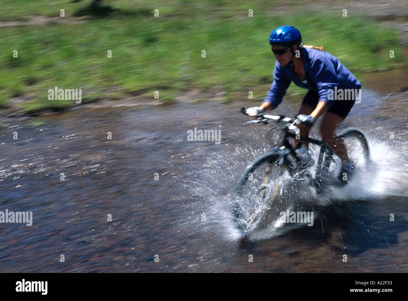 Woman Riding Bicycle in Stream Stock Photo - Alamy