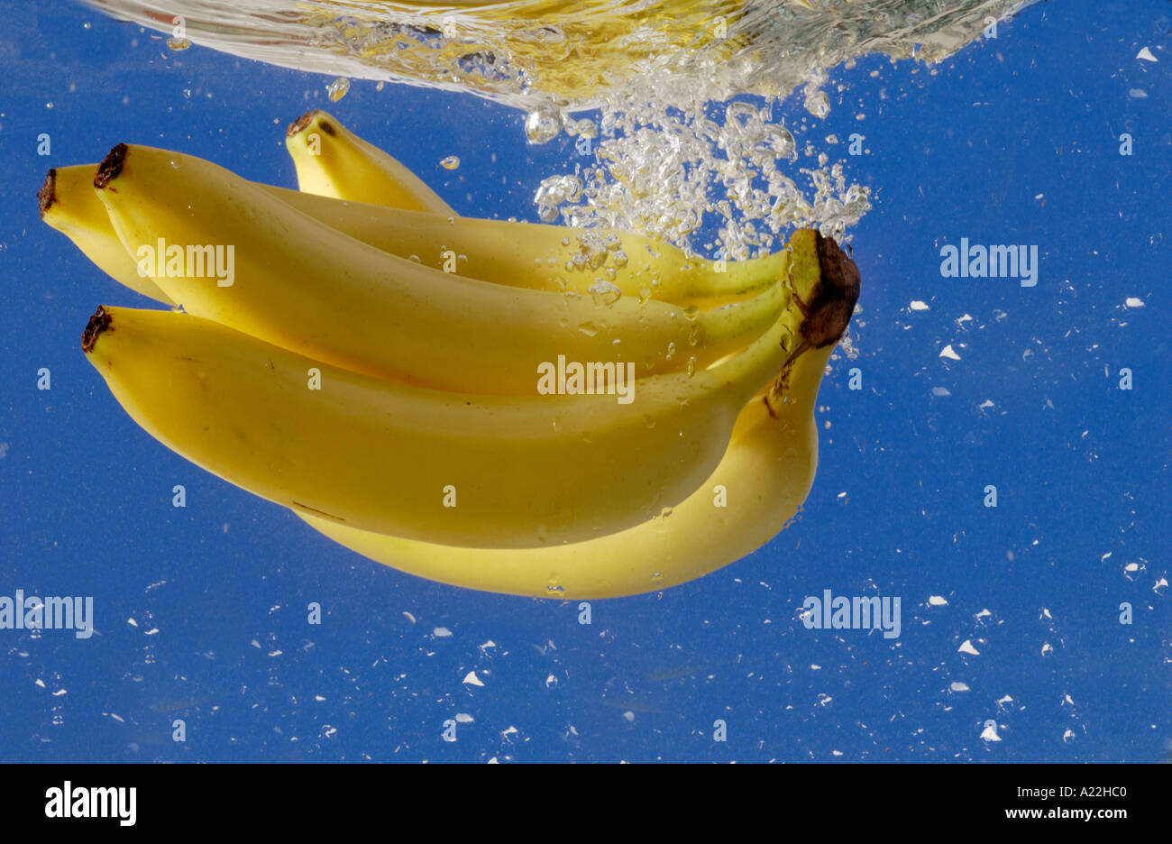 banana fruit dropped into water making splash Stock Photo - Alamy