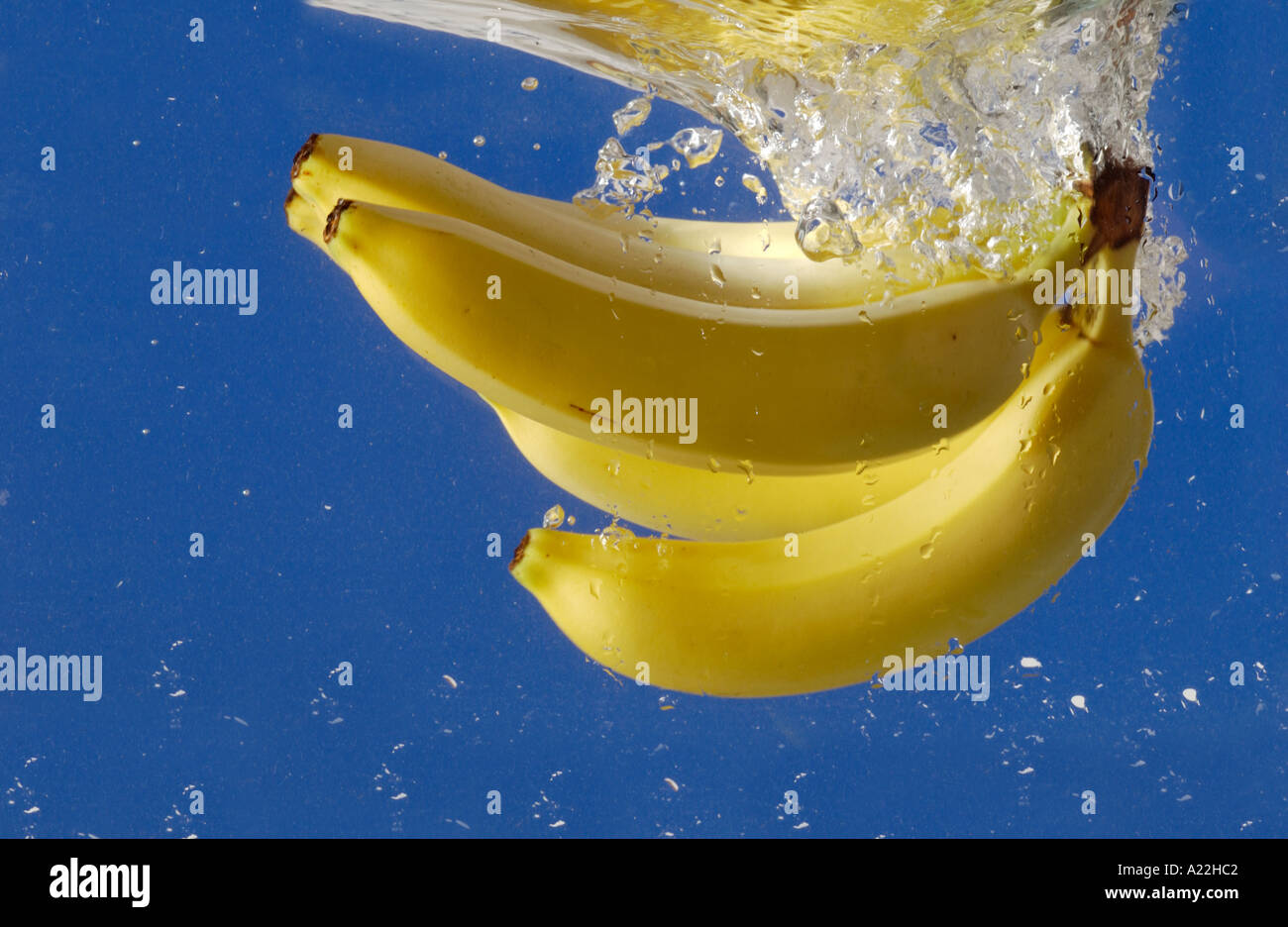 banana fruit dropped into water making splash Stock Photo - Alamy