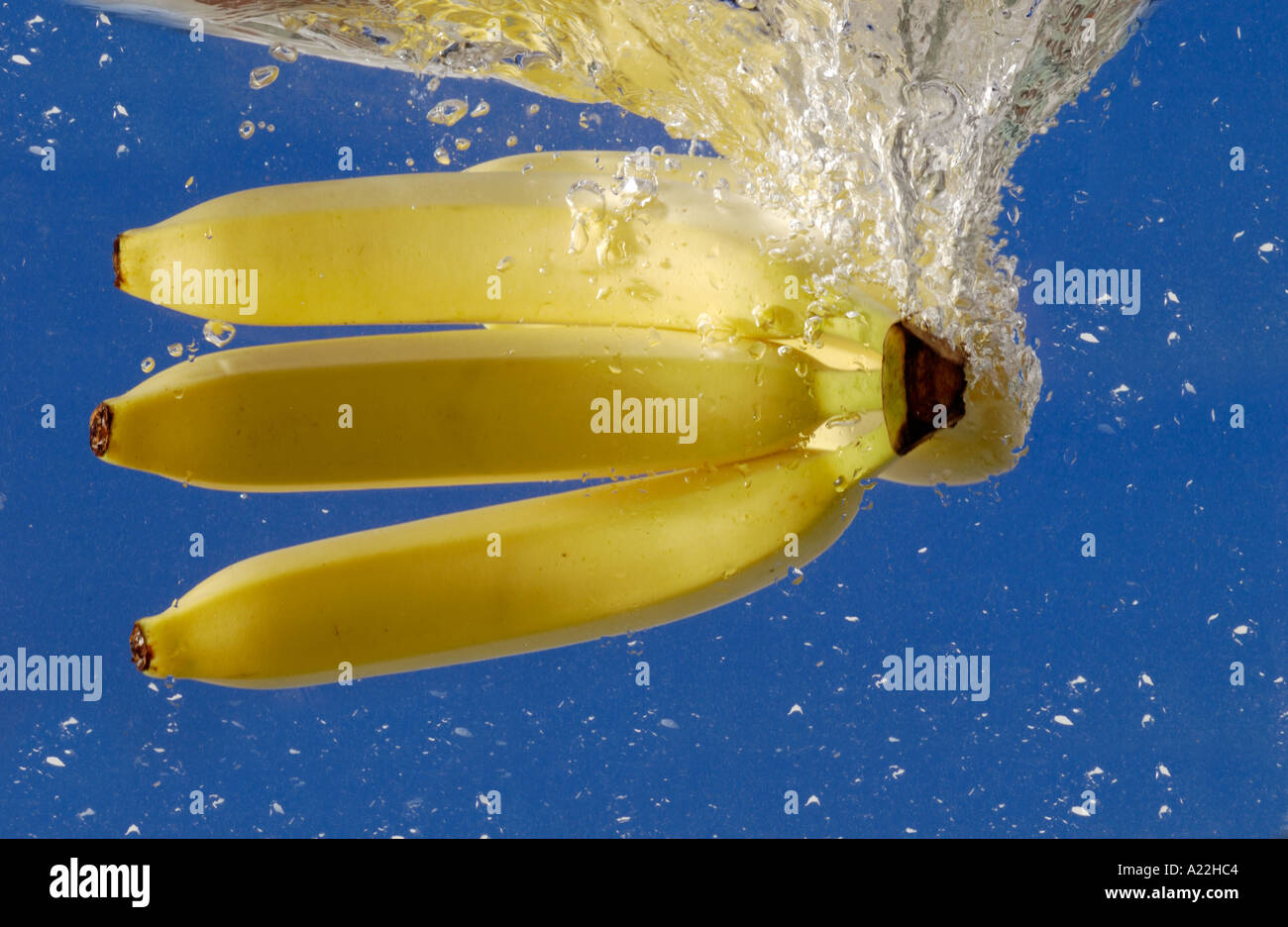 banana fruit dropped into water making splash Stock Photo - Alamy