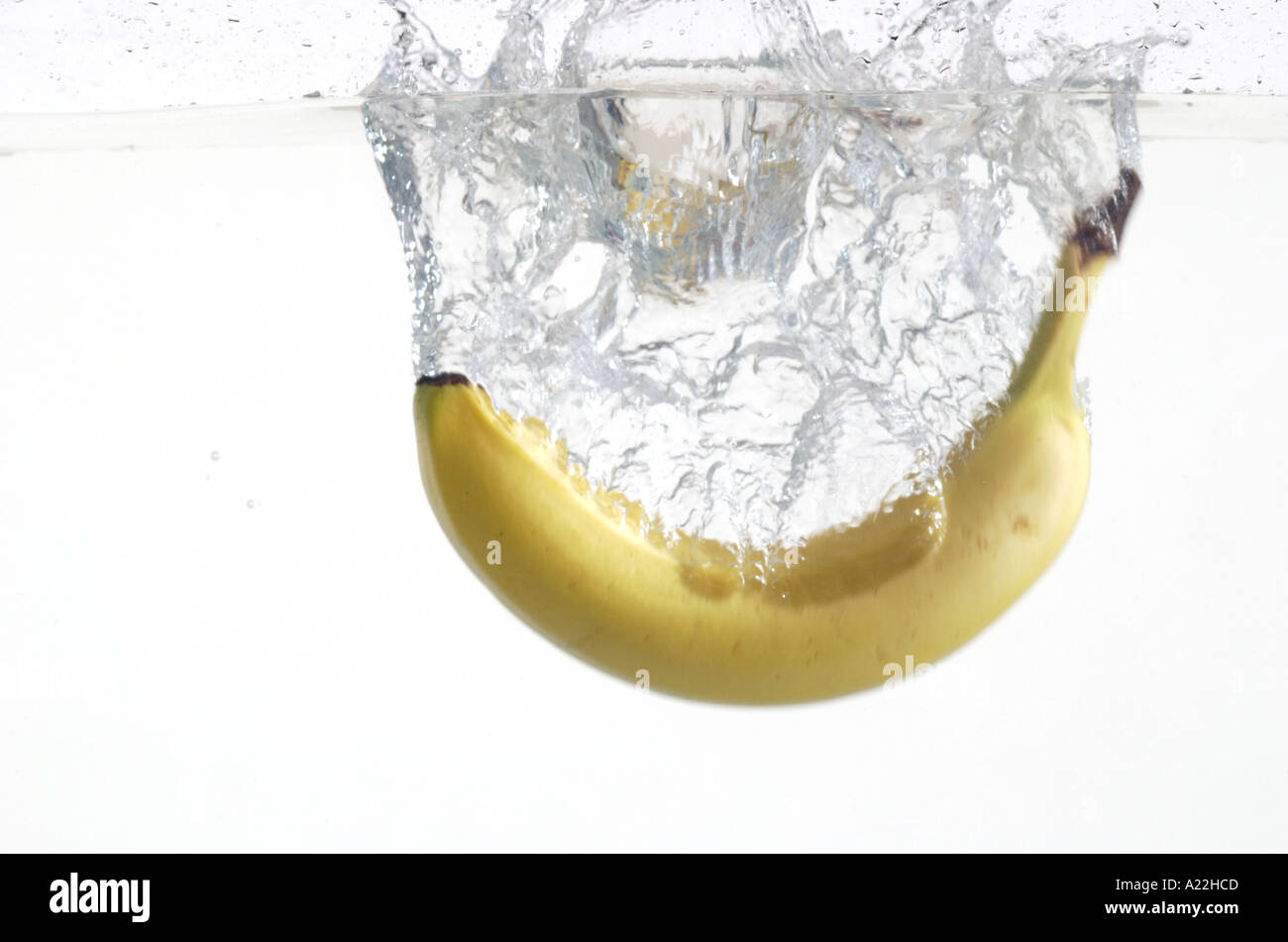 banana fruit dropped into water making splash Stock Photo - Alamy