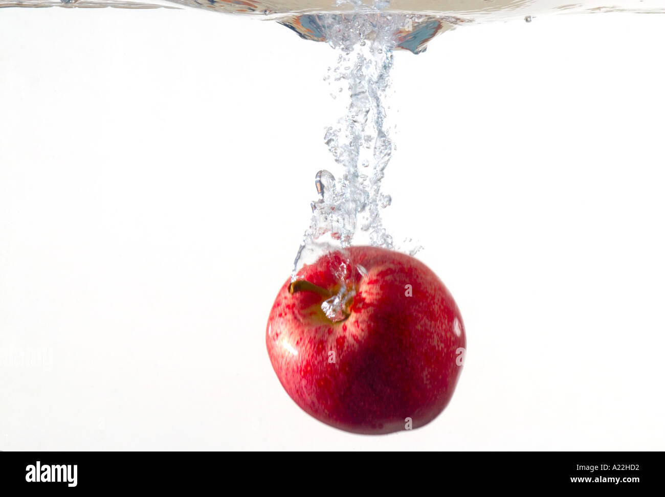 apple fruit dropped into water making splash Stock Photo - Alamy