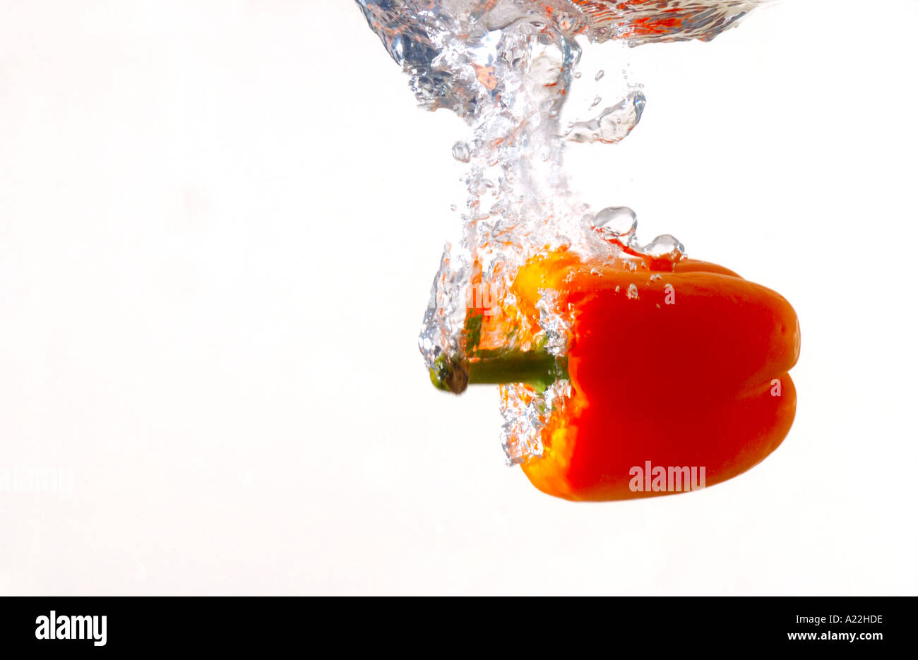 bell pepper vegetable dropped into water making splash Stock Photo - Alamy