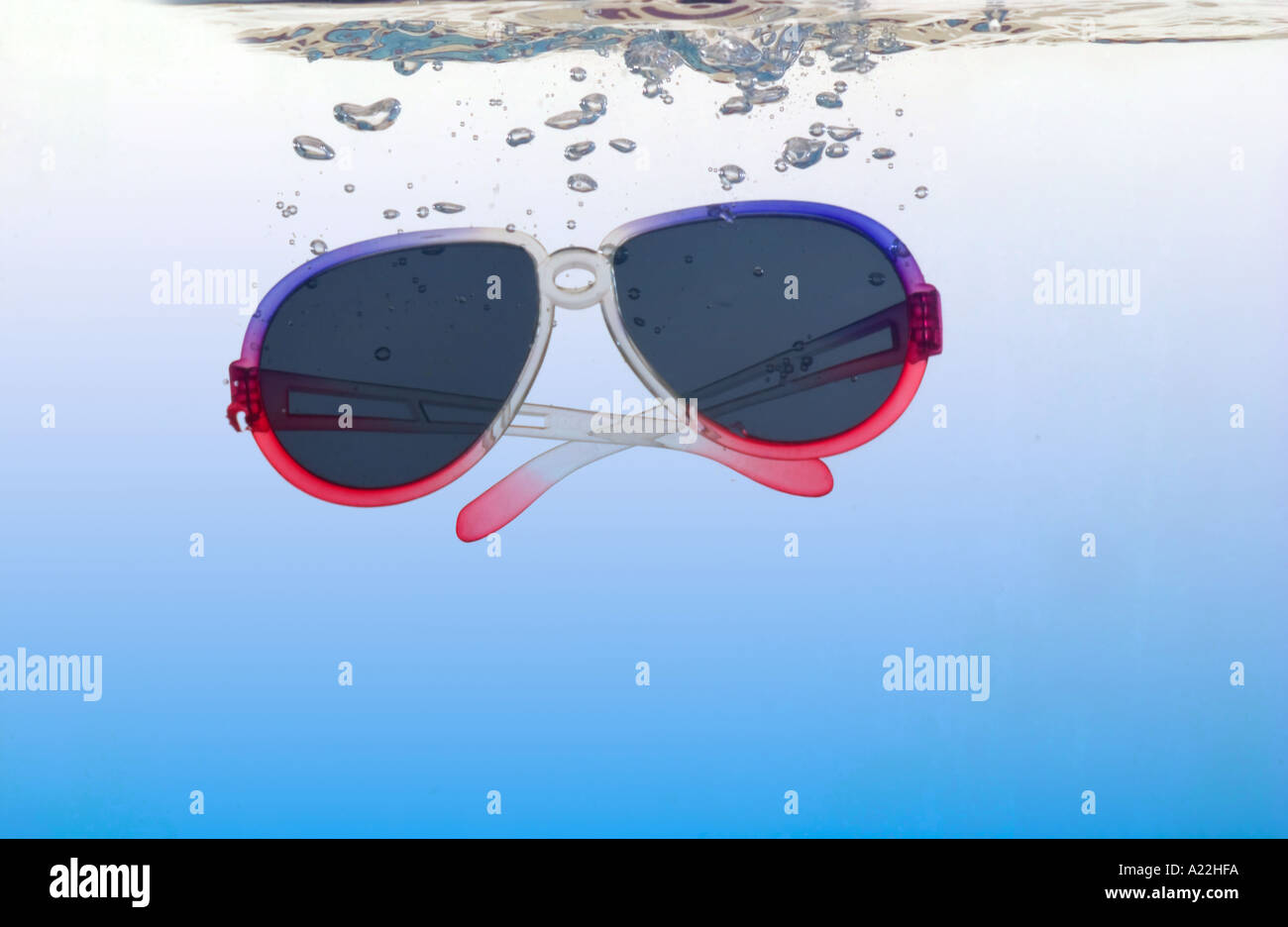 sunglasses falling into water with splash and bubbles Stock Photo - Alamy