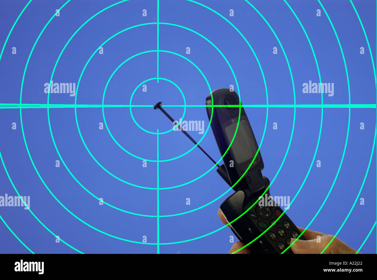 hand holding cell telephone showing conceptual radar signal rings ...