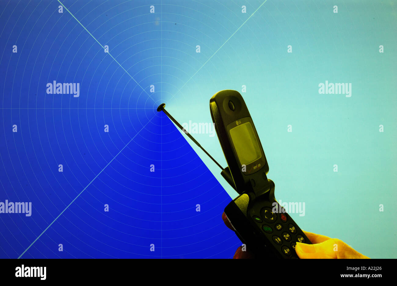 hand holding cell telephone showing conceptual radar signal rings ...