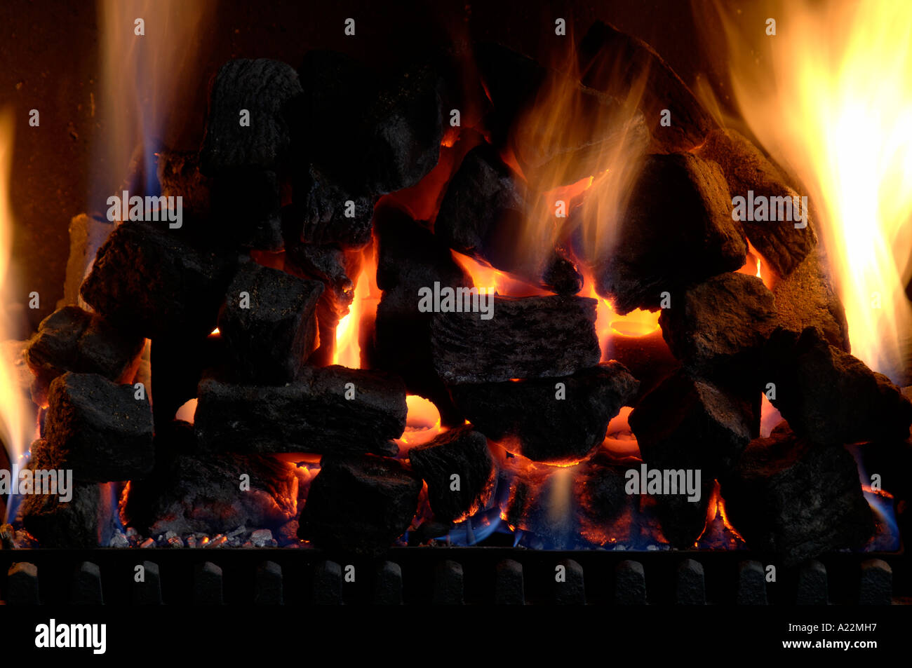 glowing coals and flames on a gas powered fire Stock Photo - Alamy
