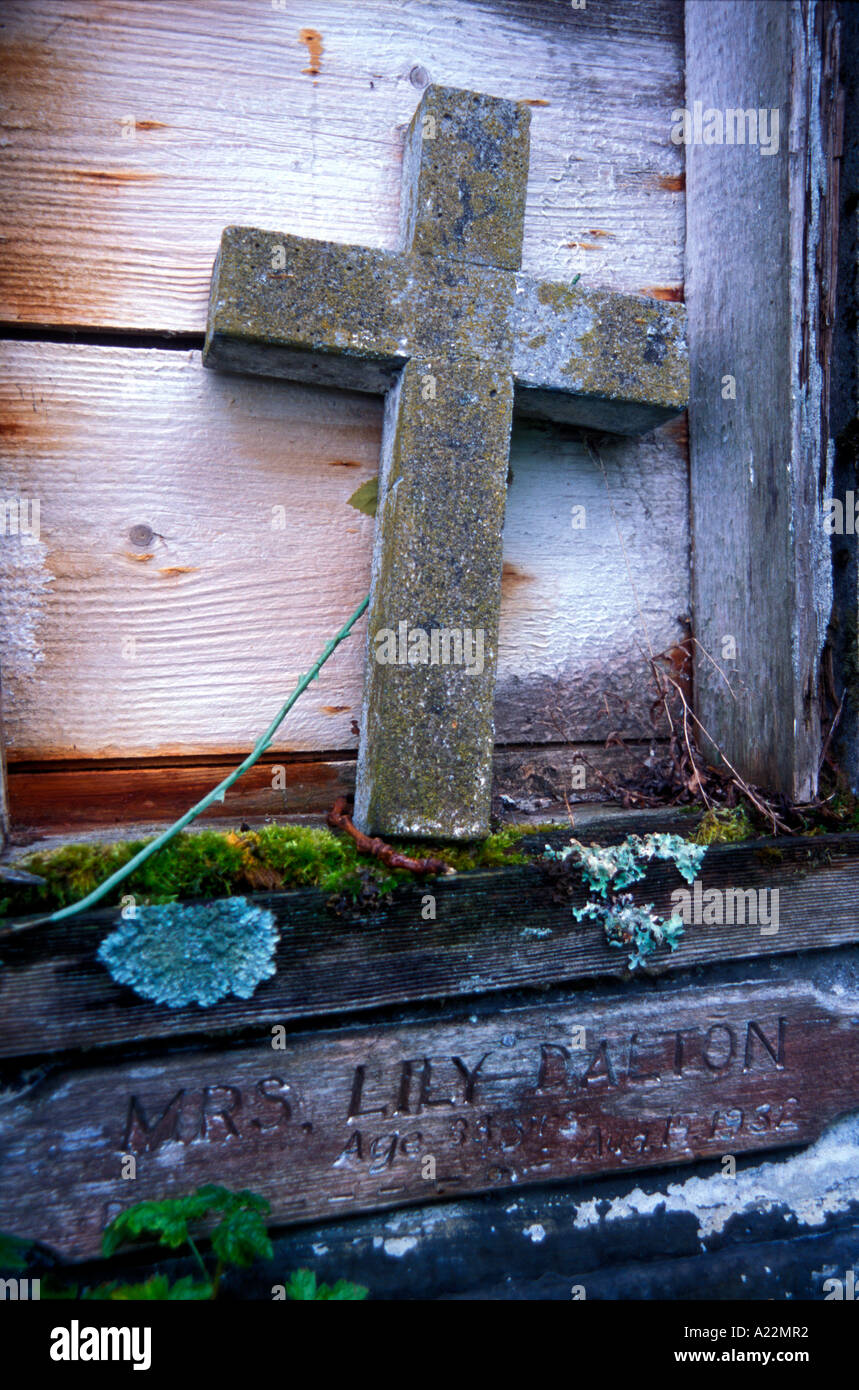 An algae crusted old stone cross stands in an Southeastern Alaskan ...