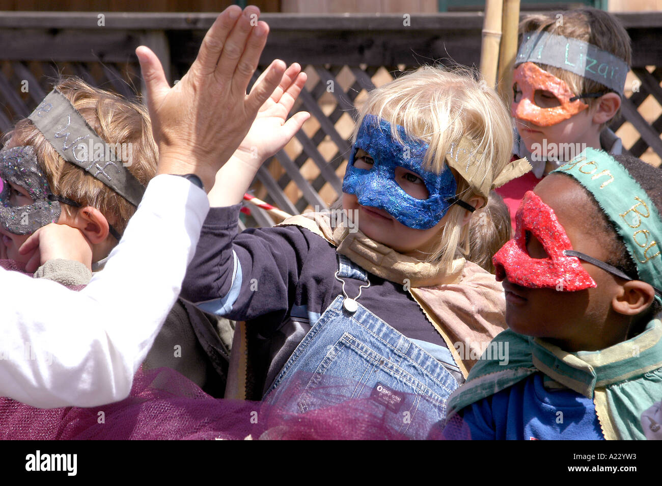 Boys in masks at the July 4th celebration parade giving a high five ...