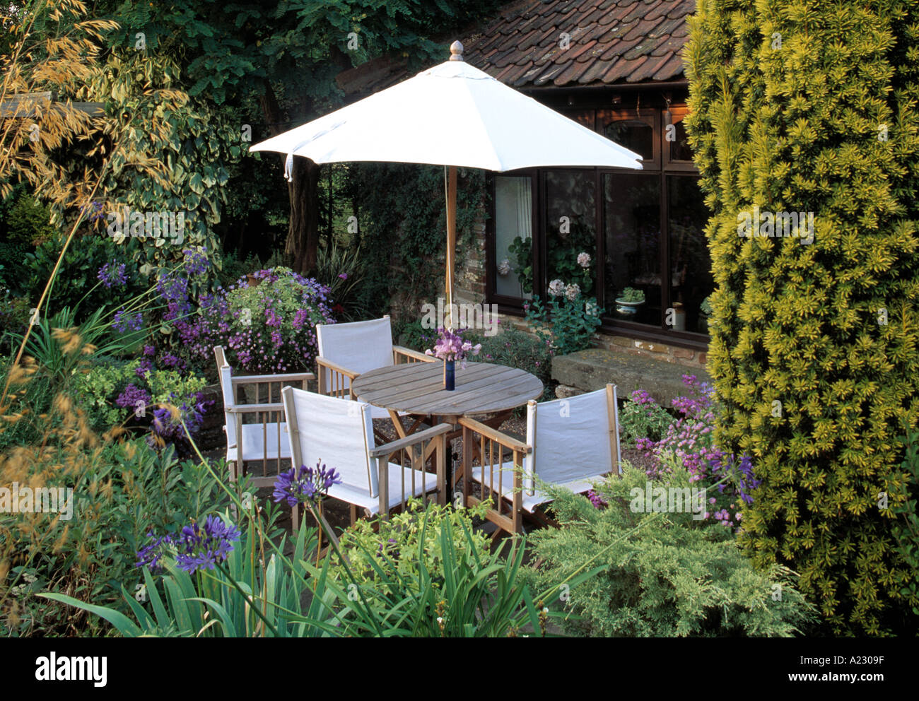 Sunshade chairs table on terrace Stock Photo - Alamy
