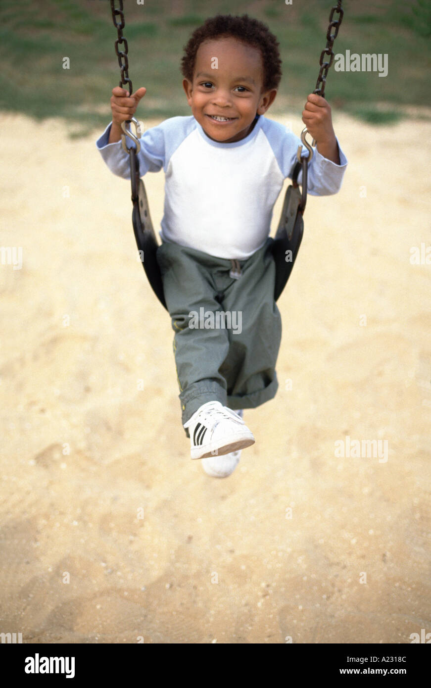 Boy on swing Stock Photo - Alamy