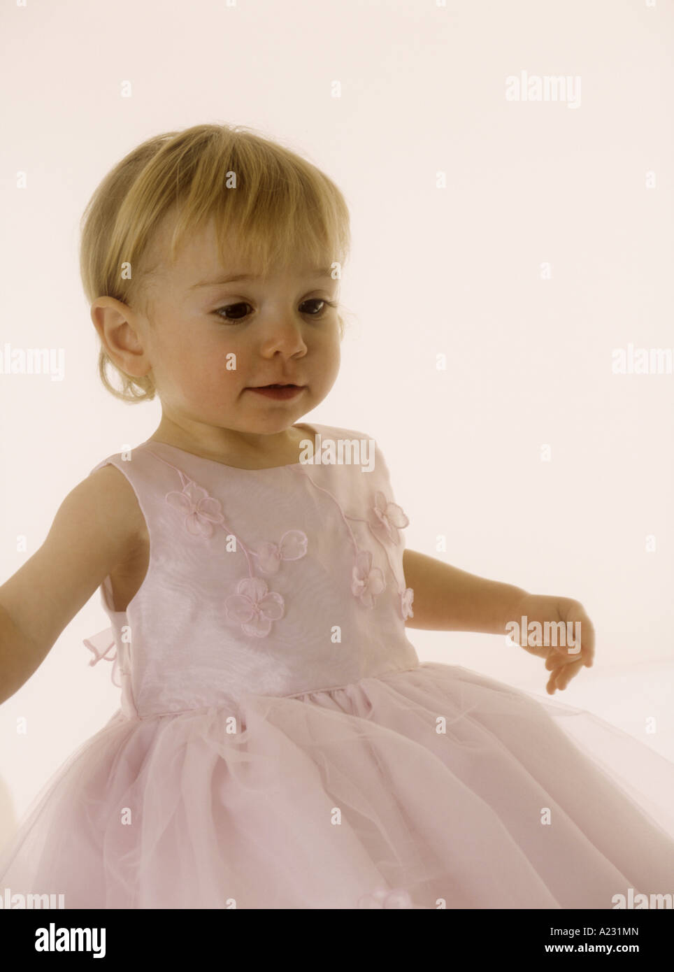 Toddler wearing a pink party dress- dancing Stock Photo - Alamy