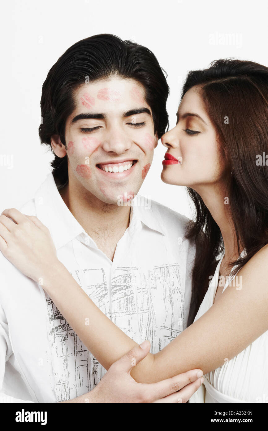 Side profile of a young woman kissing a young man Stock Photo - Alamy
