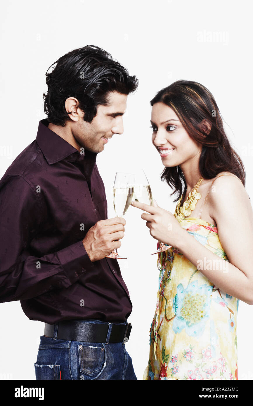 Side profile of a young couple toasting with champagne flutes Stock ...
