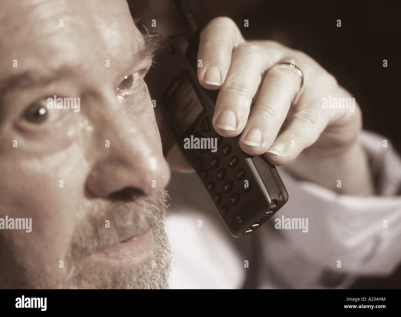 Elderly Man Talking on a Mobile Cellular Phone Looking Up and Asking a ...