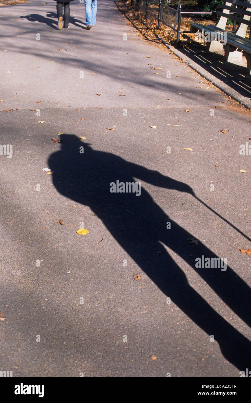 Shadow of an elderly man with a cane walking in the park alone Stock ...