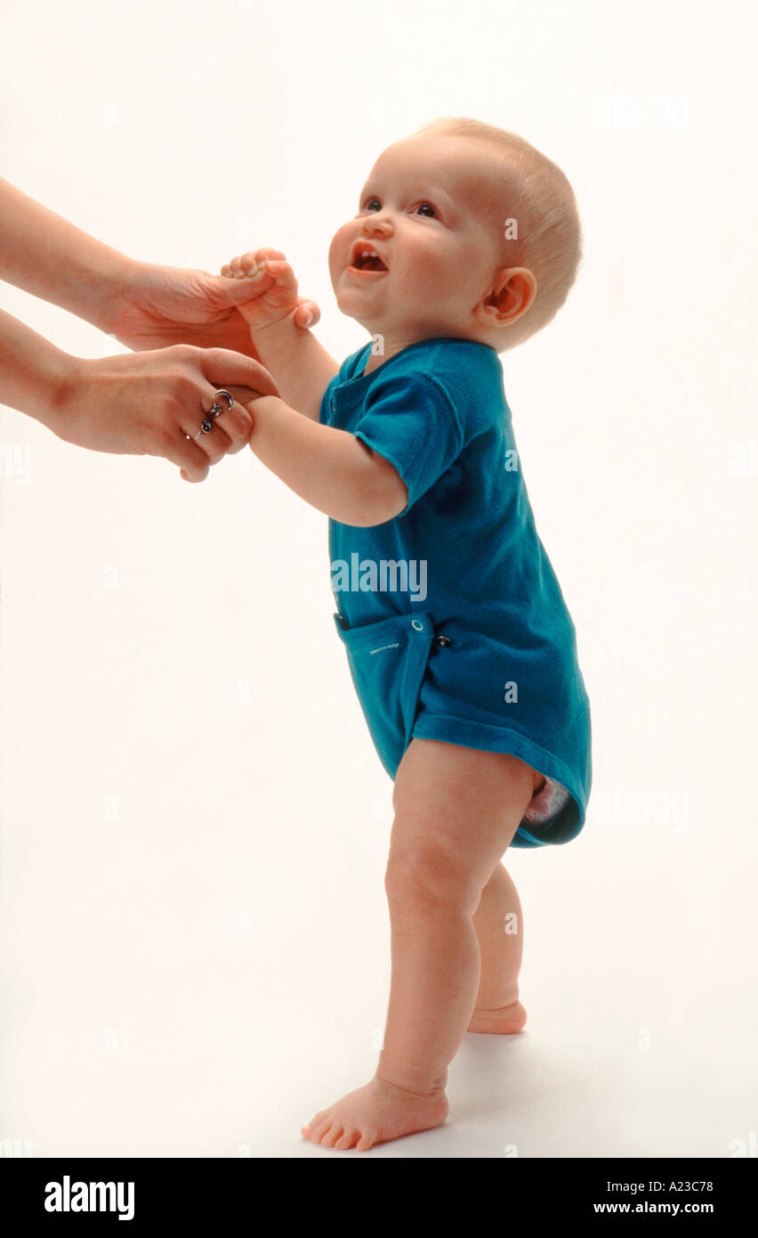 Baby girl taking first steps hi-res stock photography and images - Alamy