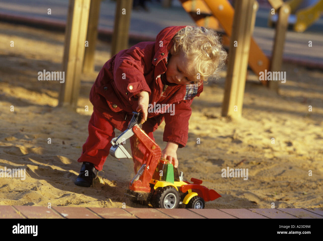 toddler playing with a digger toy in sand pit Stock Photo - Alamy