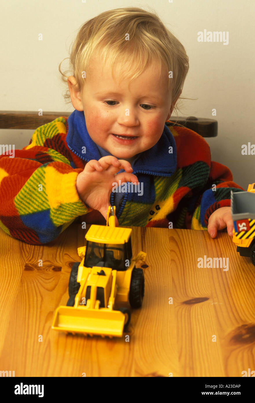 toddler playing with model digger Stock Photo - Alamy