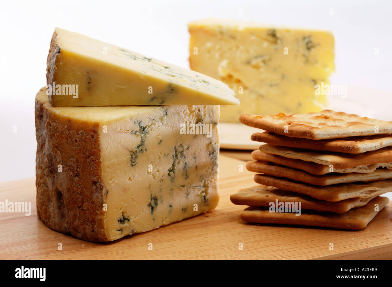 Wedge of stilton with pile of cream cracker biscuits Stock Photo - Alamy