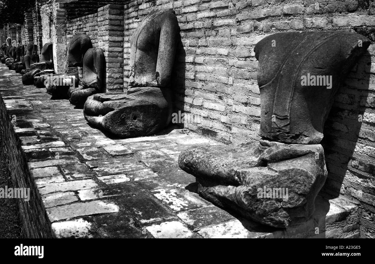 Damaged ancient statues in a row inside the remains of a ruined ...