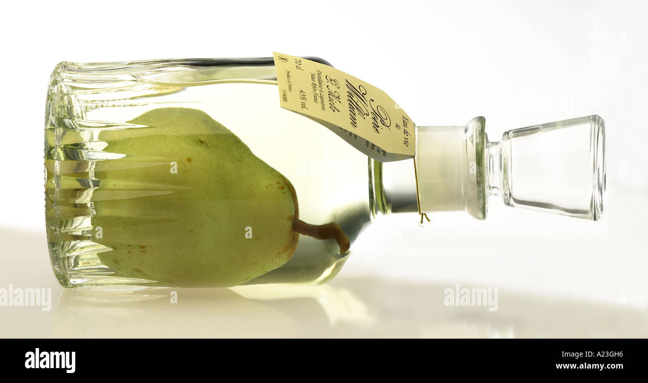 Poire William pear in bottle of brandy bottle lying on its side Stock ...