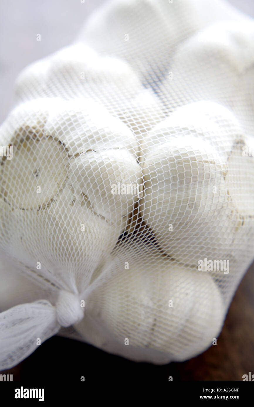 Garlic in net bag Stock Photo - Alamy