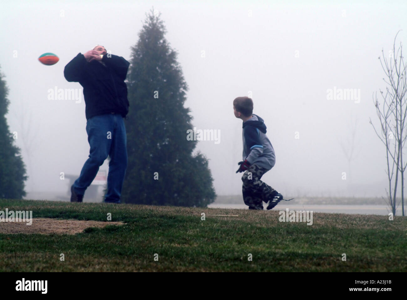 Father son playing football catch hi-res stock photography and images ...