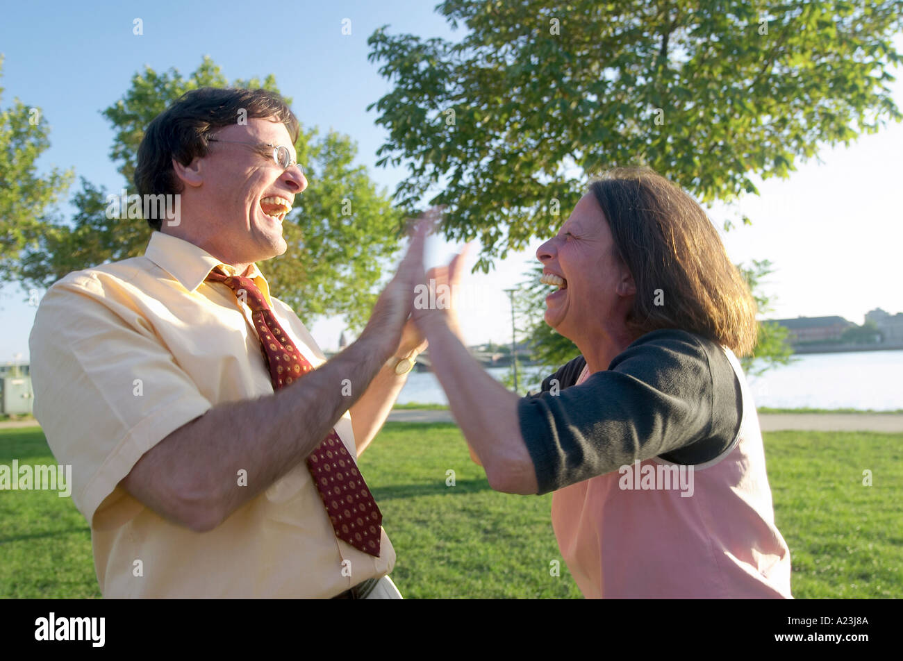 Man and Woman laughing and clapping hands together Stock Photo - Alamy