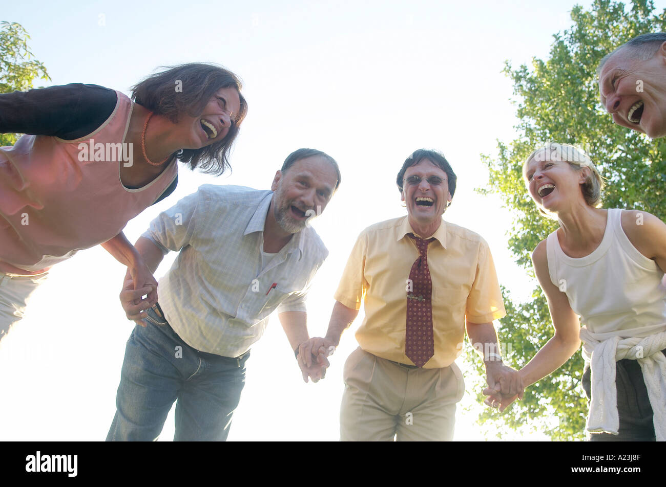 Row of 4 People holding hands Stock Photo - Alamy