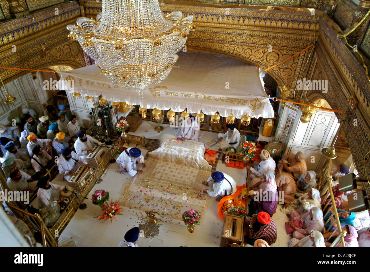 Congregation in the presence of Guru Granth Sahib holy scripture inside ...