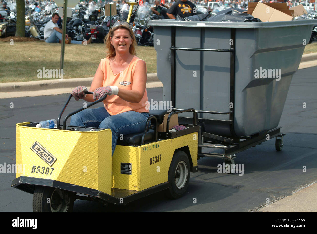 A women picking garbage refuse during motor cycle rally Stock Photo - Alamy