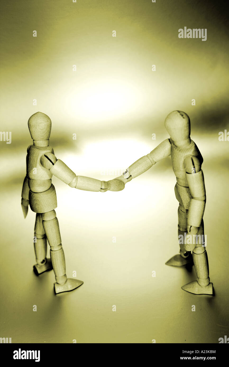 Wooden figures shaking hands Stock Photo - Alamy