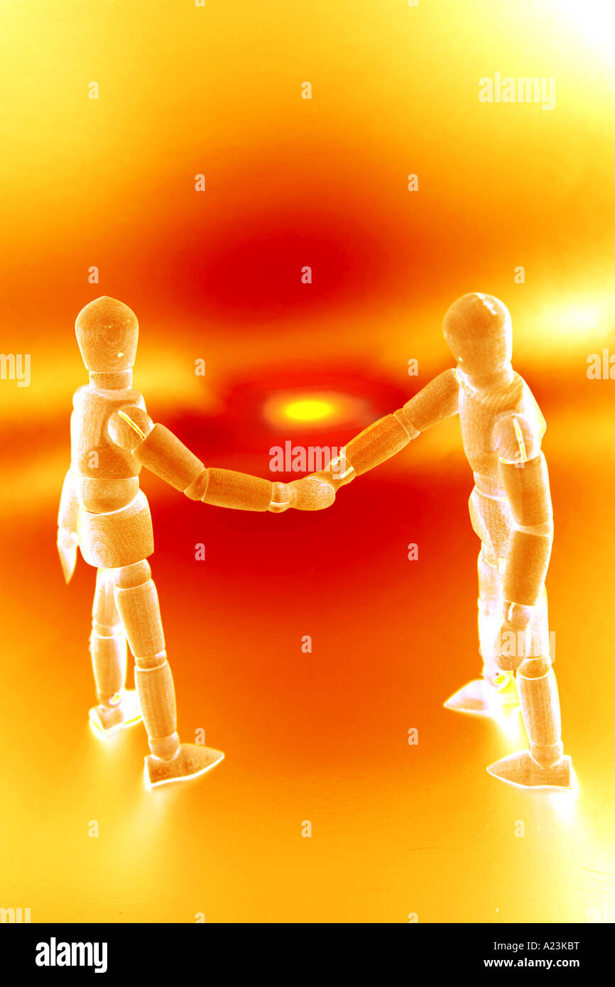 Wooden figures shaking hands Stock Photo - Alamy