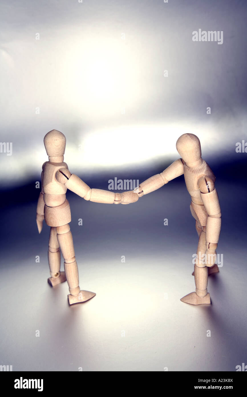 Wooden figures shaking hands Stock Photo - Alamy