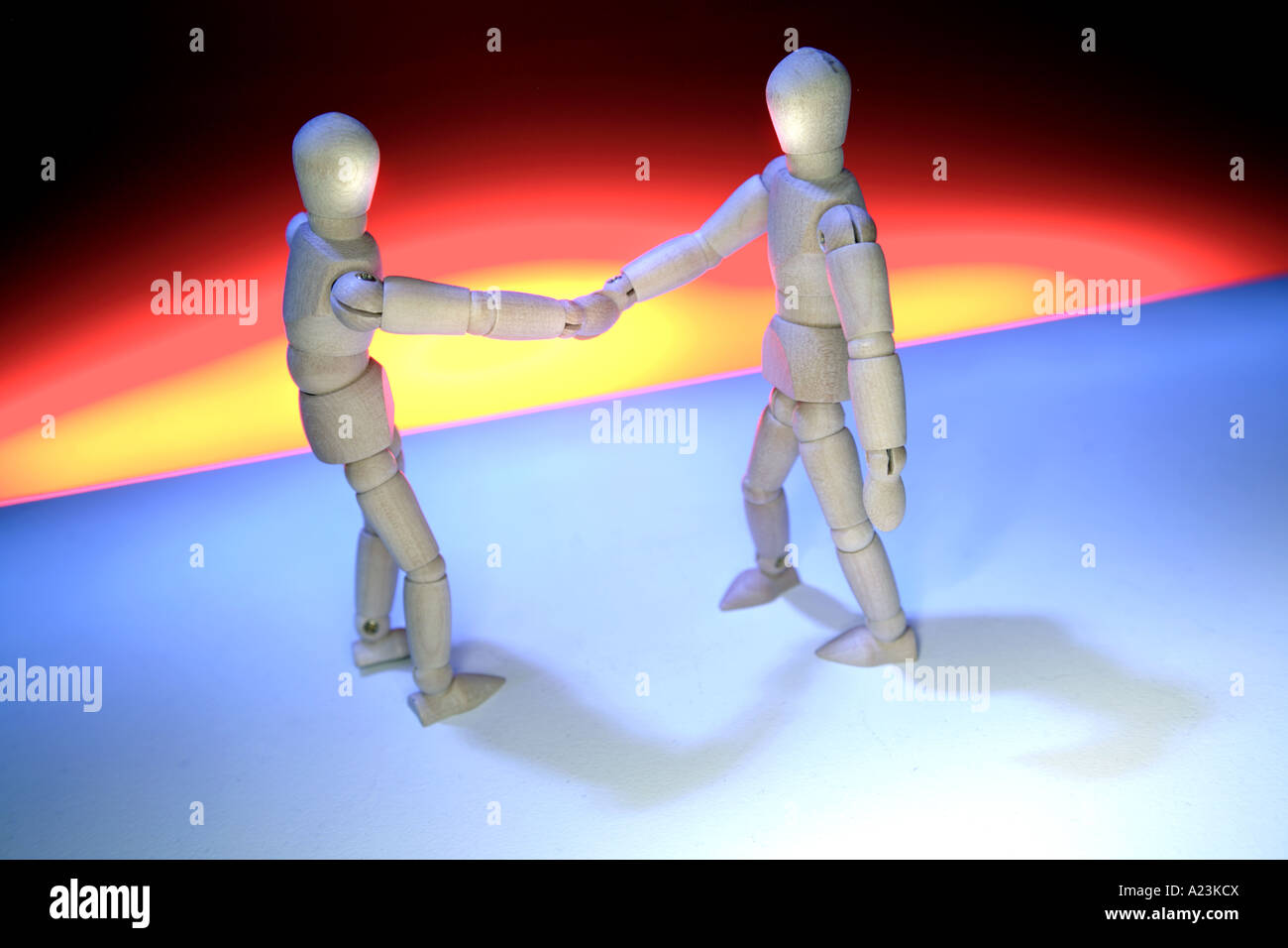 Wooden figures shaking hands Stock Photo - Alamy