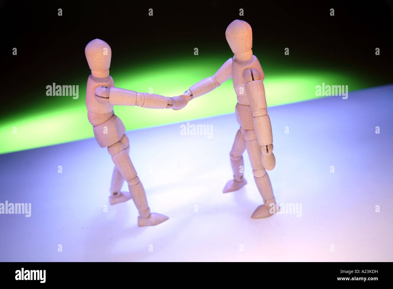 Wooden figures shaking hands Stock Photo - Alamy