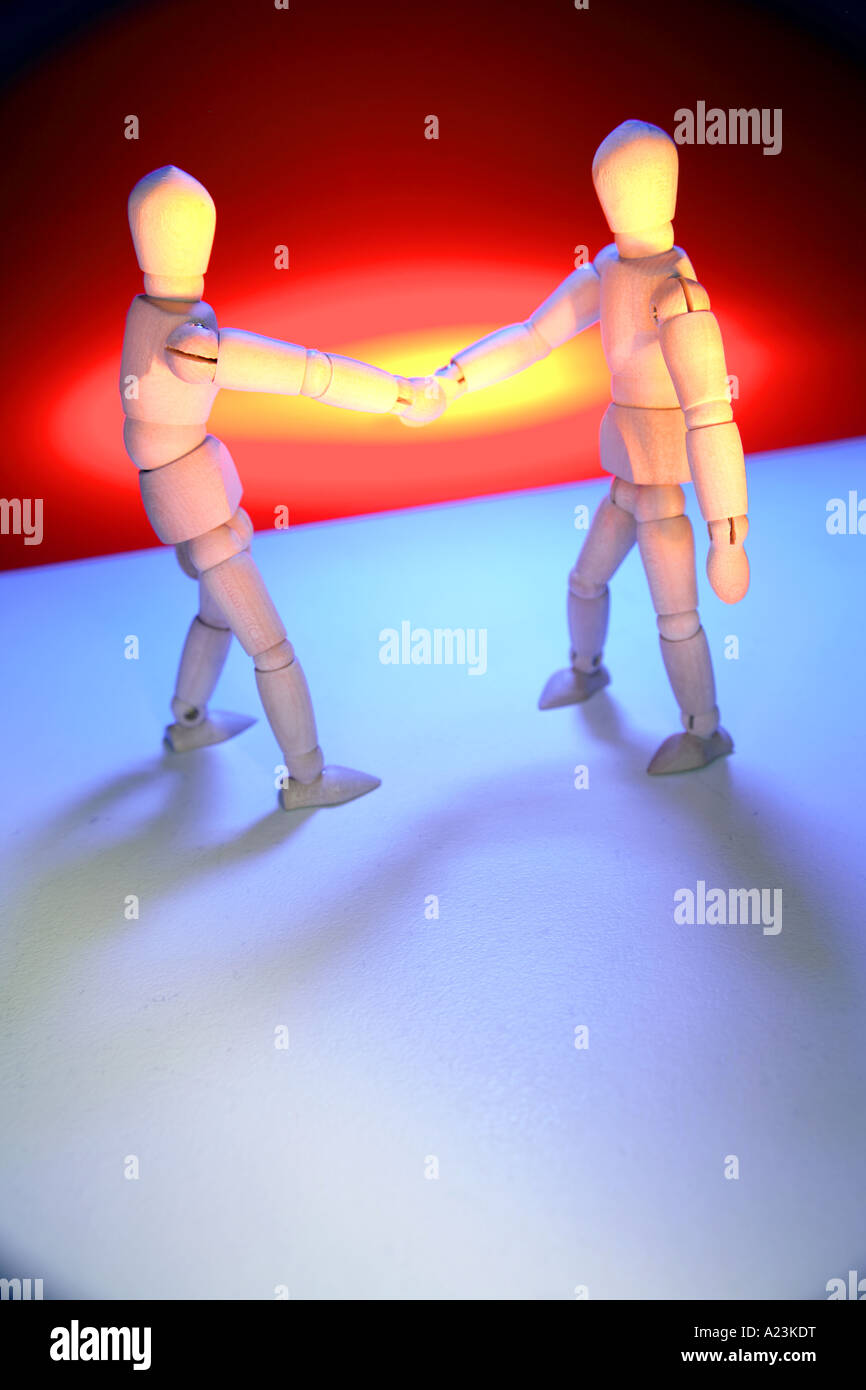 Wooden figures shaking hands Stock Photo - Alamy
