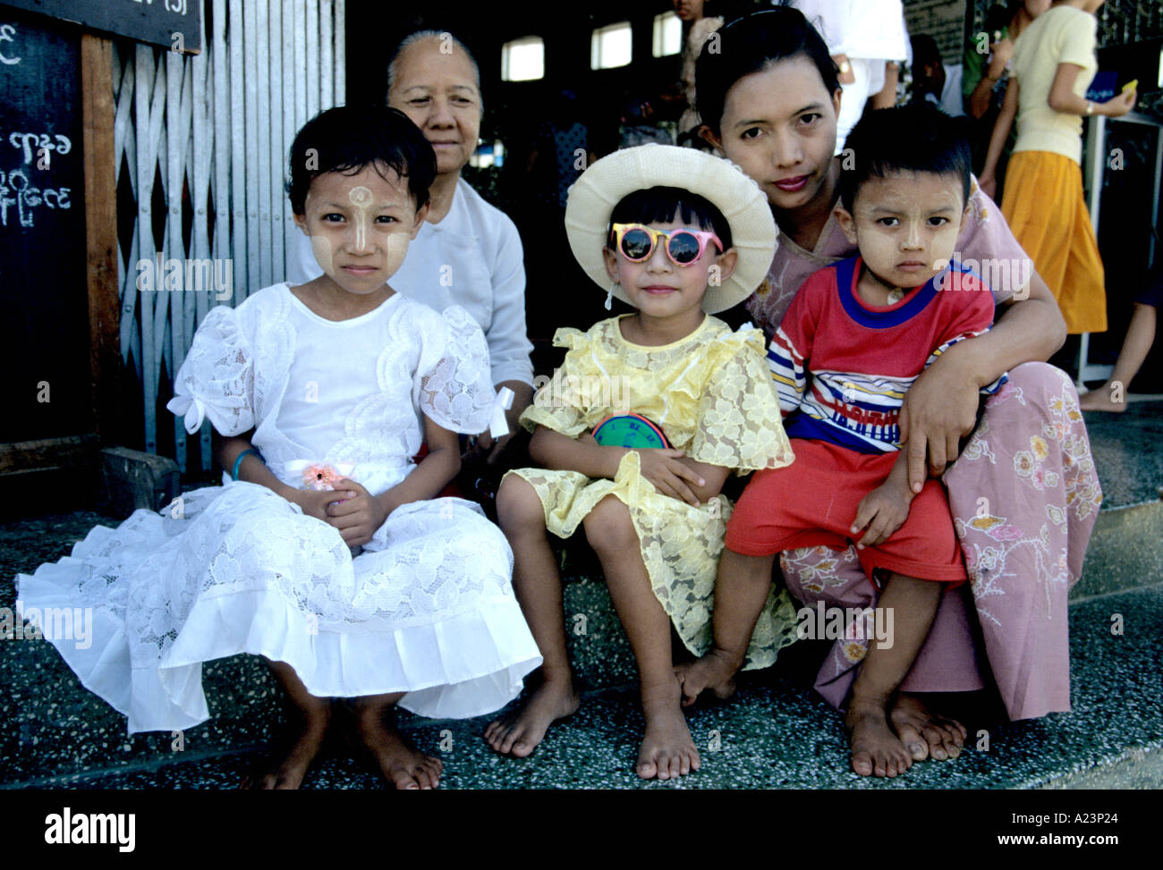Burmese family in party finery with Tanaka bark paste protecting their ...
