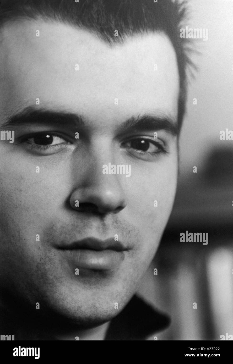 Face of a young man serious Stock Photo - Alamy