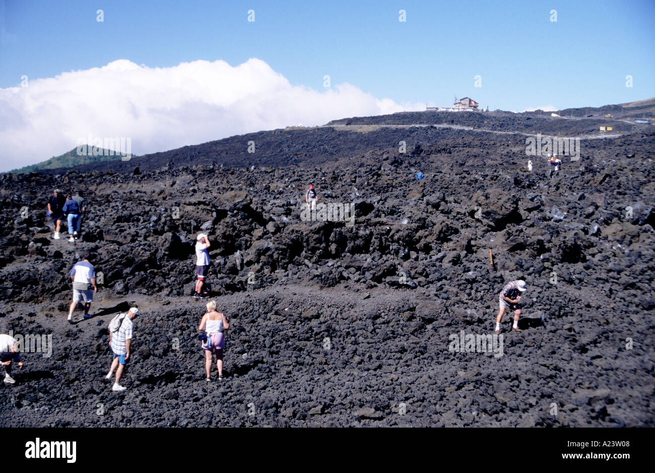 Tourists exploring the lava fields of Mount Etna after a volcanic ...