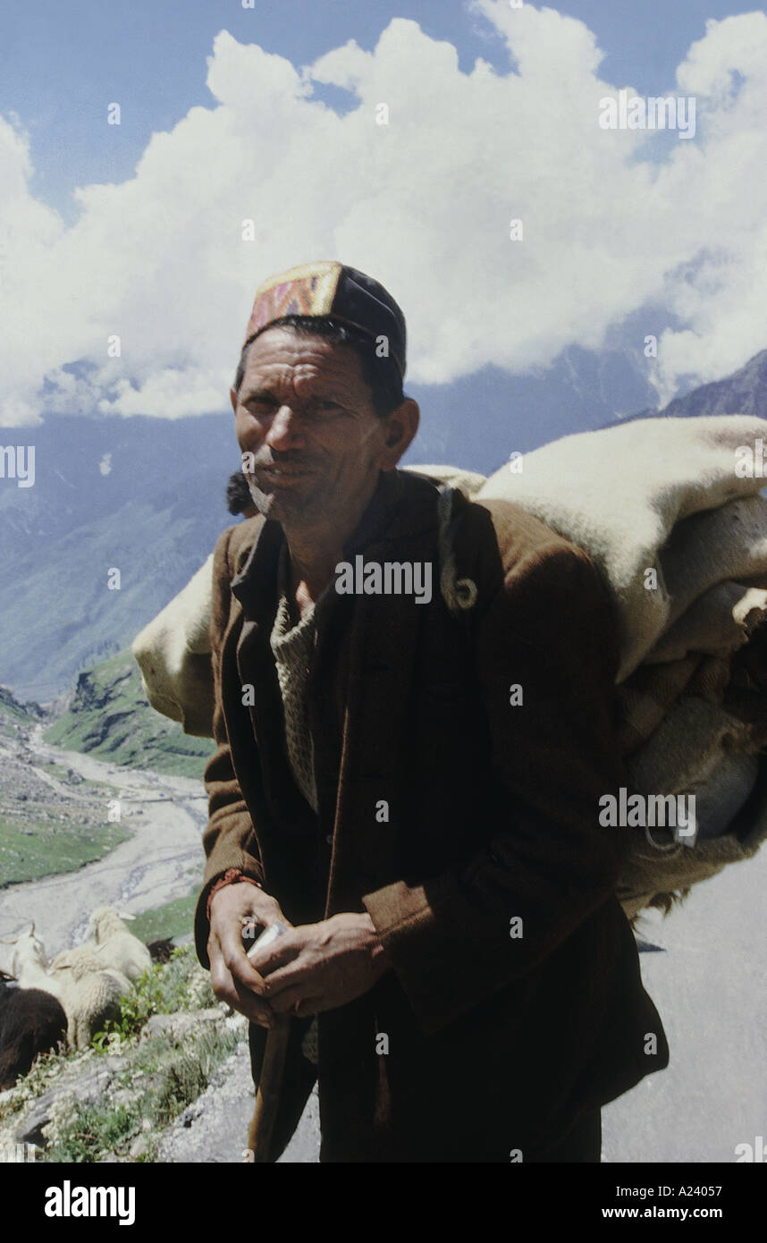 A porter carrying goods on his back in the hills of the Himalayas Stock ...
